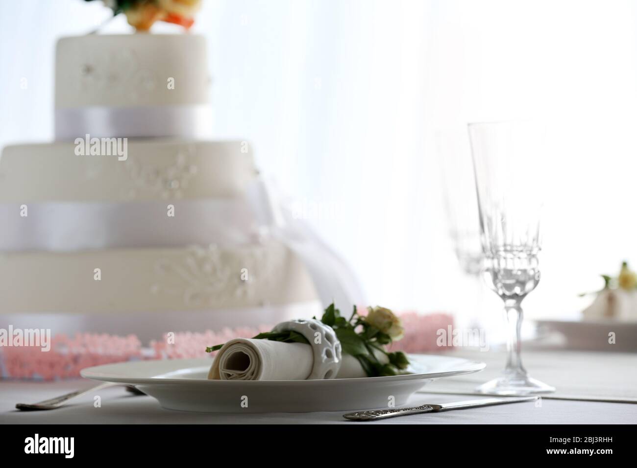 Wedding layered cake in decorated restaurant on window background Stock ...