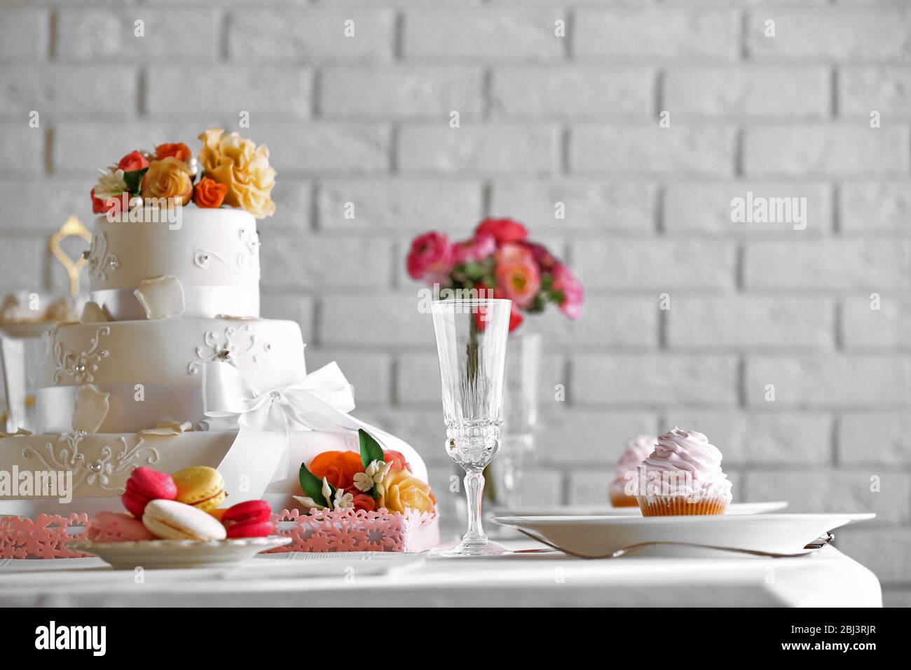 Beautiful decorated table for wedding on white wall background Stock ...