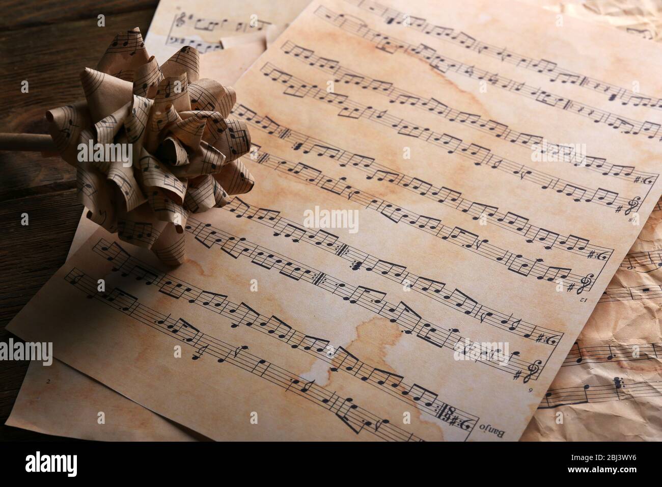 Beautiful paper-made rose on musical notes page background Stock Photo ...