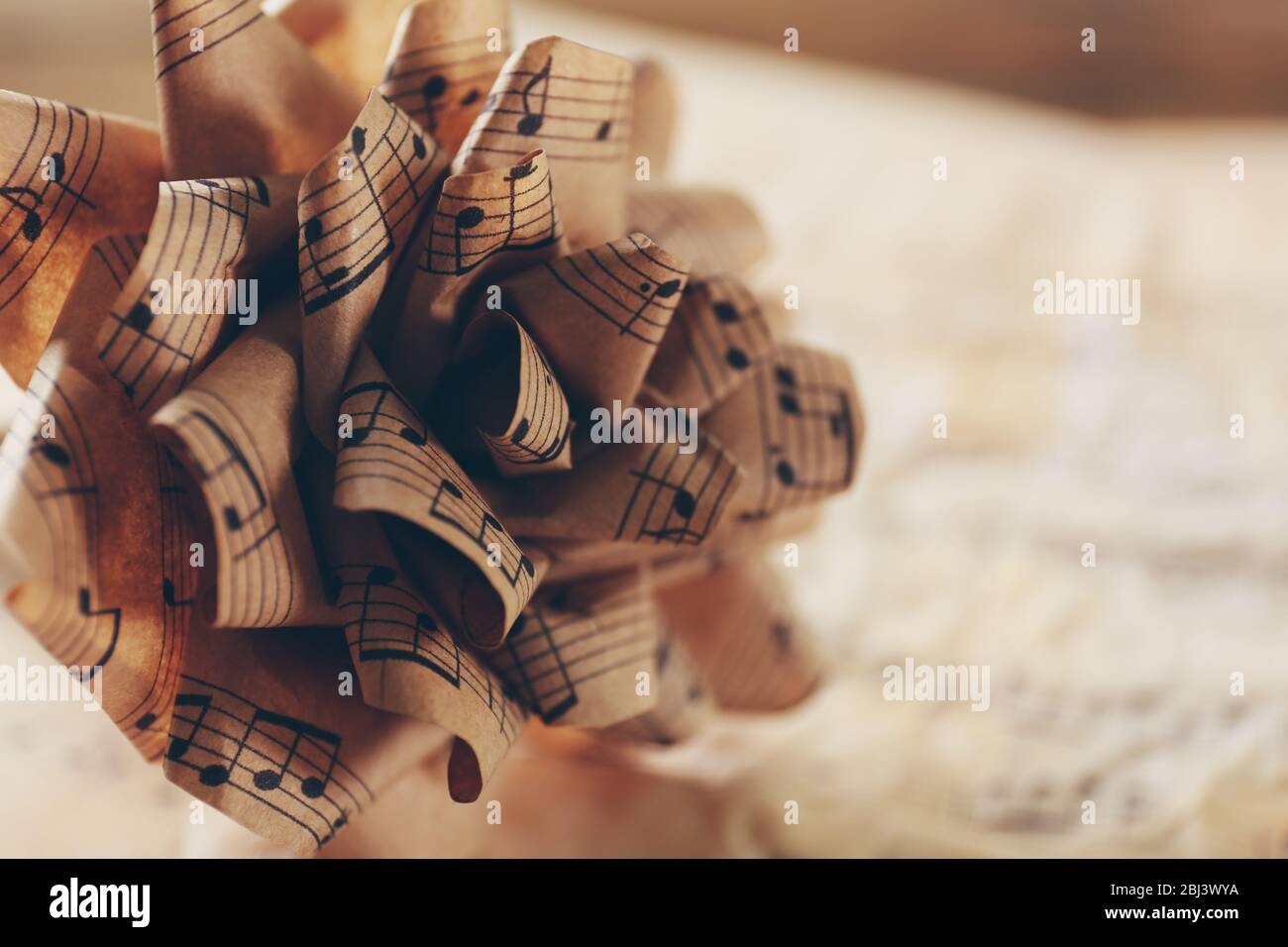 Beautiful paper-made rose on musical notes page background Stock Photo ...
