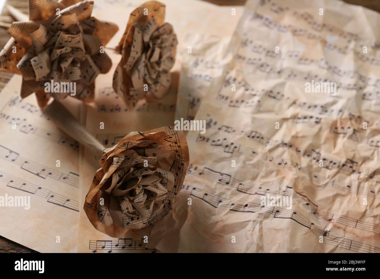 Beautiful paper-made roses on musical notes page background Stock Photo ...