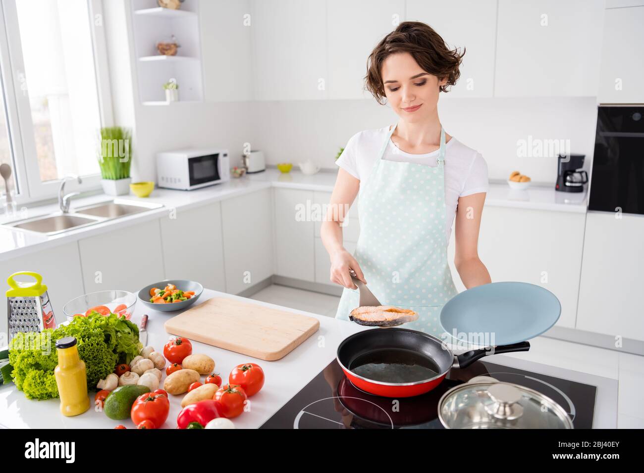 Photo of beautiful housewife lady put grilled salmon trout fillet steak ...