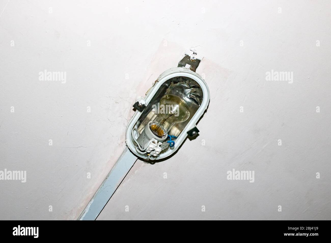 Old rusty lamp on a white wall Stock Photo - Alamy
