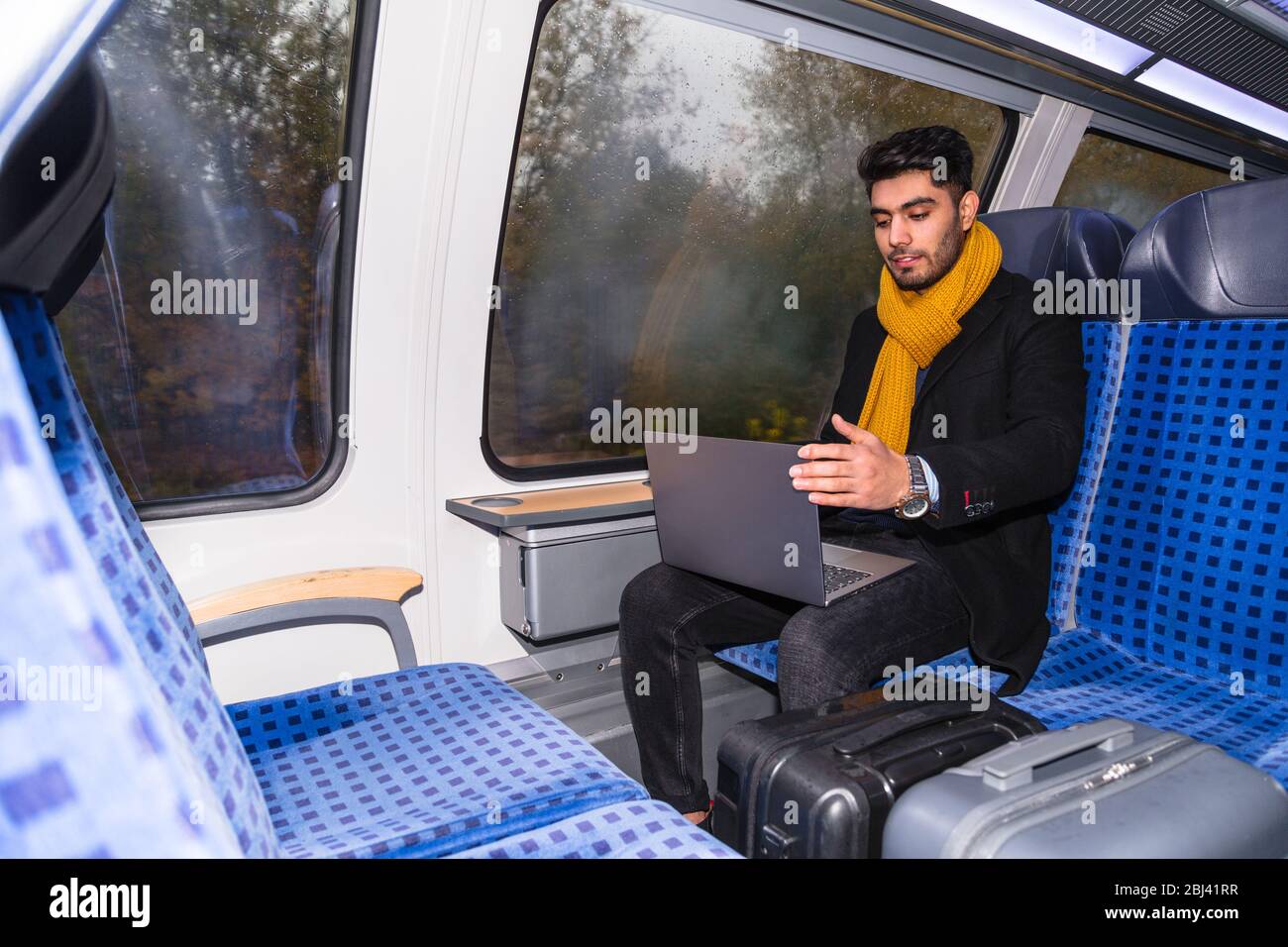 Businessman works on train using hi-res stock photography and images ...