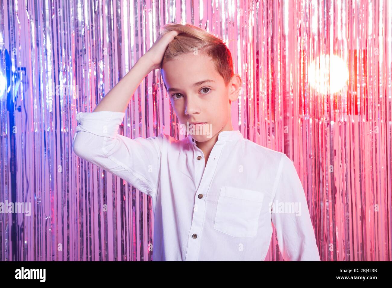 Awkward age and teenage concept - Portrait of teen boy at a party ...