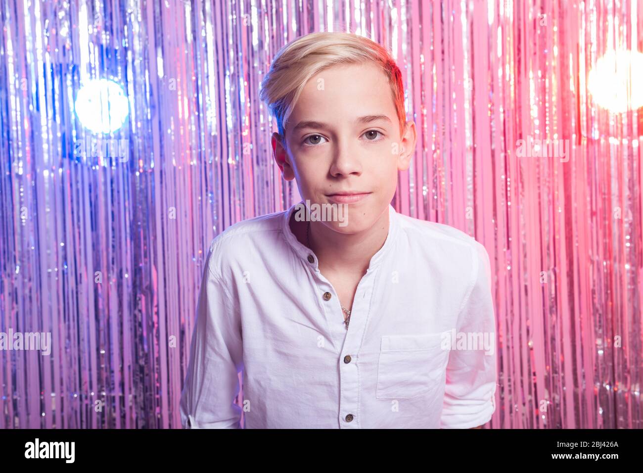 Awkward age and teenage concept - Portrait of teen boy at a party ...