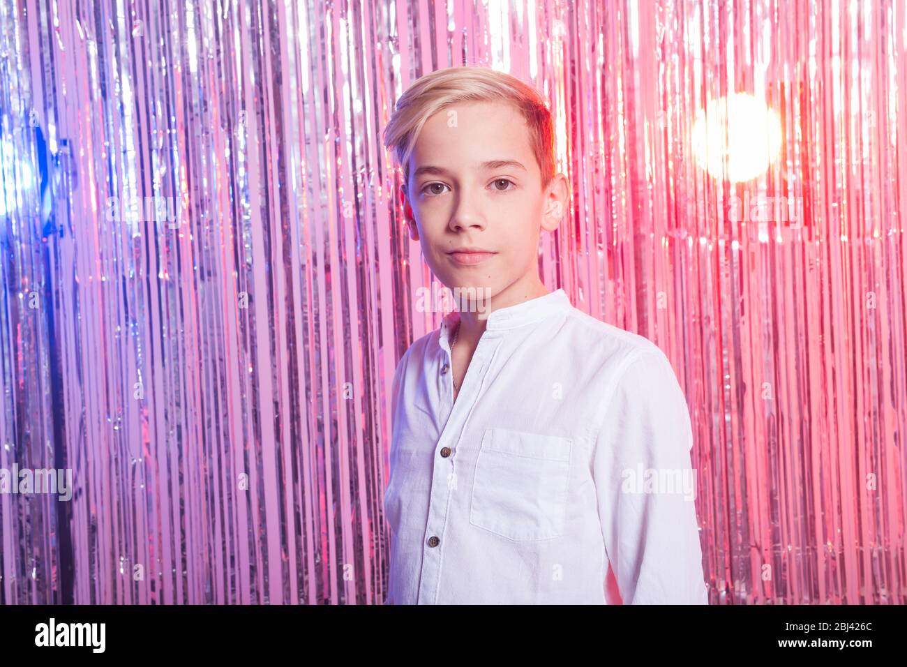 Awkward age and teenage concept - Portrait of teen boy at a party ...