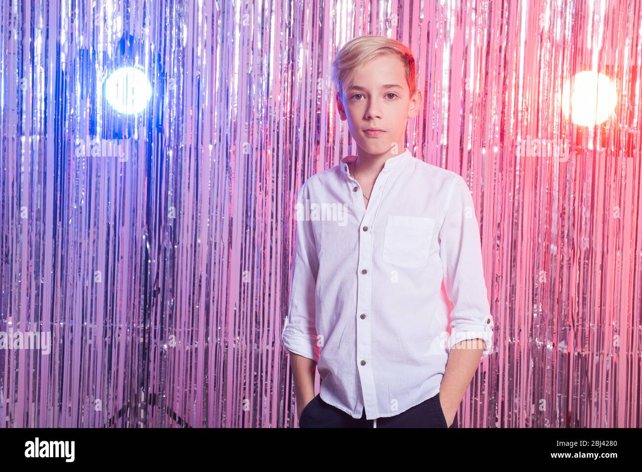 Awkward age and teenage concept - Portrait of teen boy at a party ...