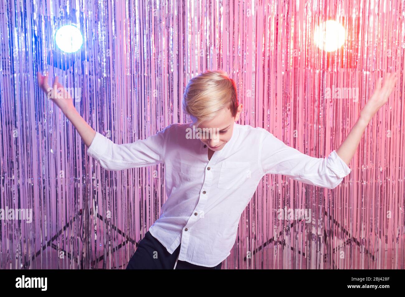 Teen boy dancing hip-hop on shiny background. Dance and child concept ...
