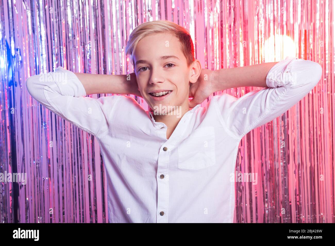 Awkward age and teenage concept - Portrait of teen boy at a party ...
