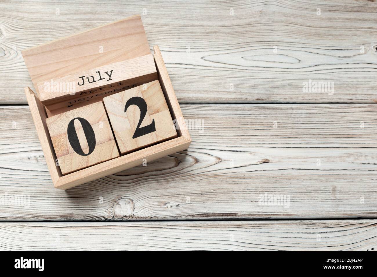 2 july wooden, square calendar. business trip or holiday planning ...