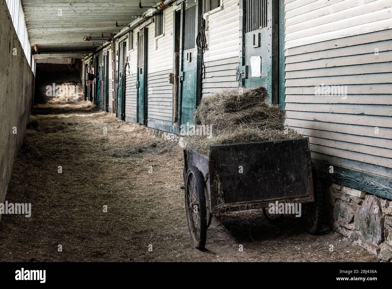 Hay cart outside stable stalls at the Morgan Horse Farm in Vermont ...