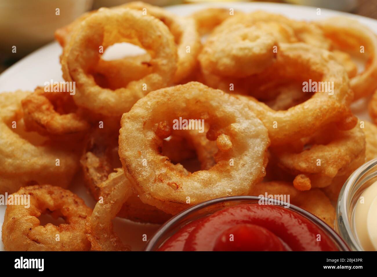 Chips rings with sauce on plate Stock Photo - Alamy