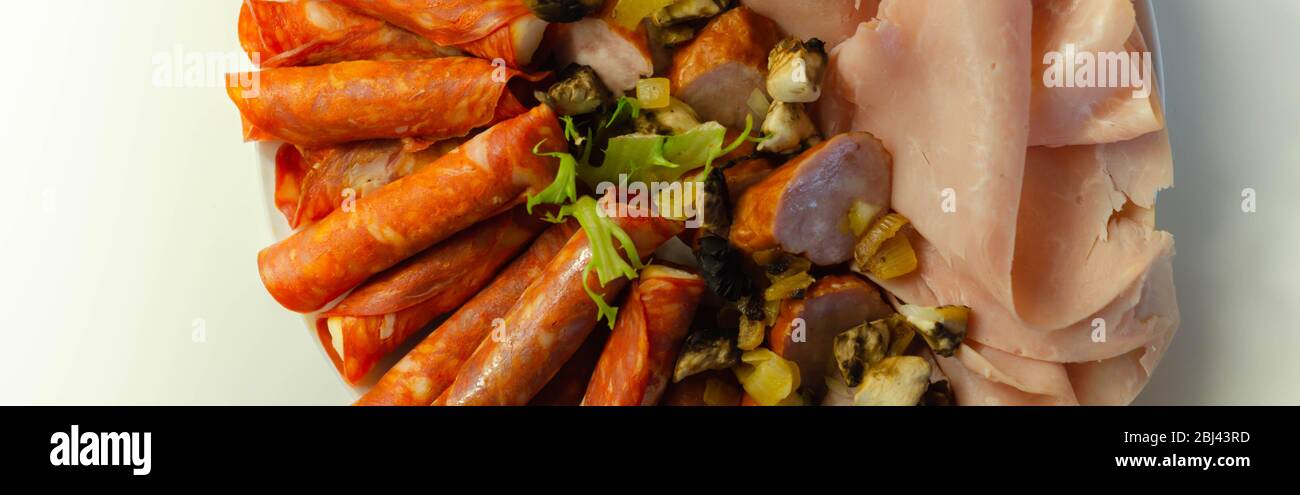 A cold plate prepared for the party with sliced chorizo, ham and ...
