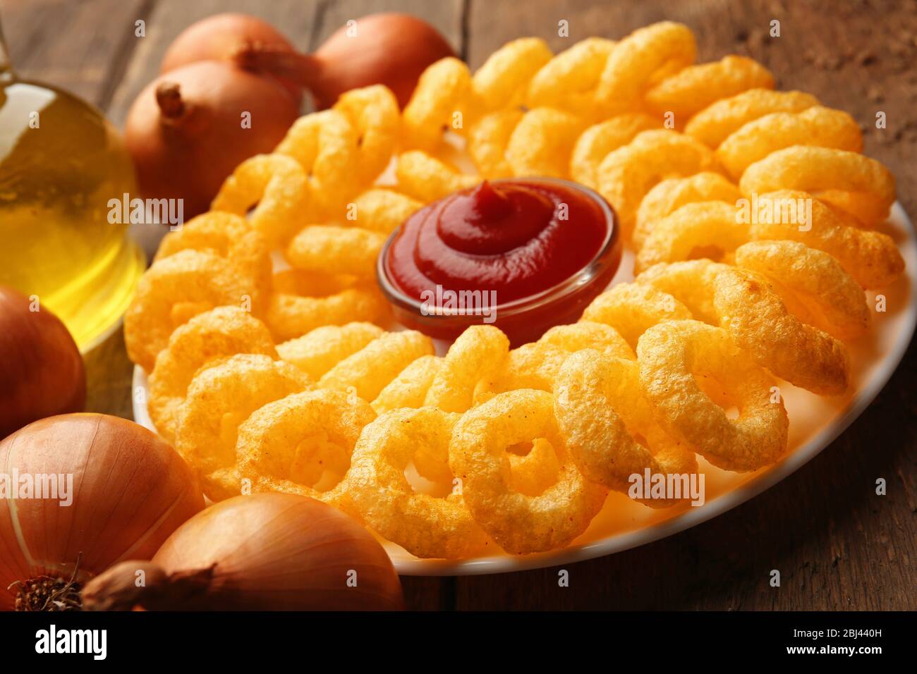 Chips rings with sauce on plate closeup Stock Photo - Alamy