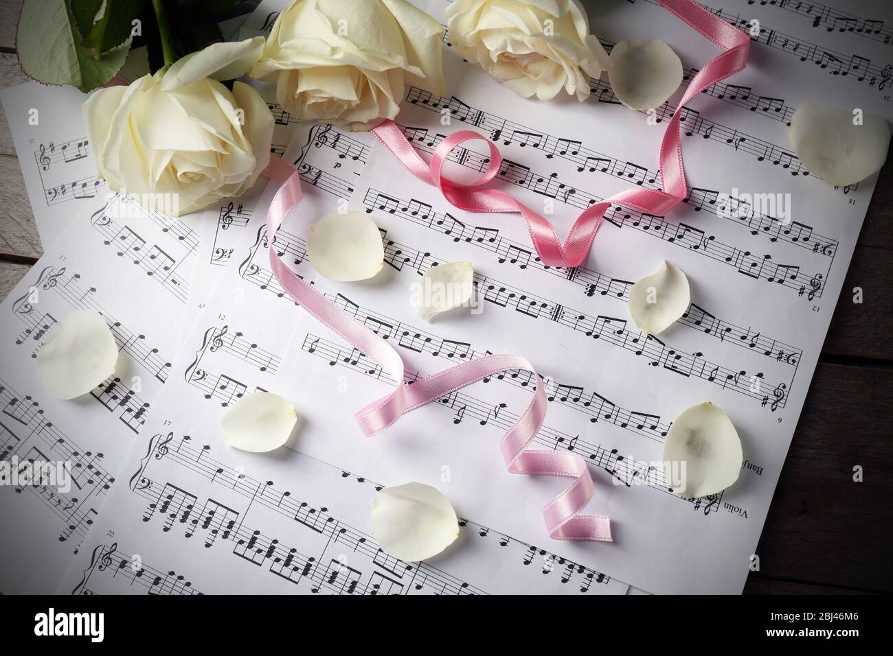 Beautiful rose on music sheets background Stock Photo - Alamy