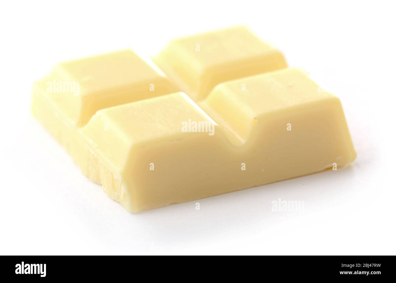 White chocolate pieces isolated on white background Stock Photo - Alamy