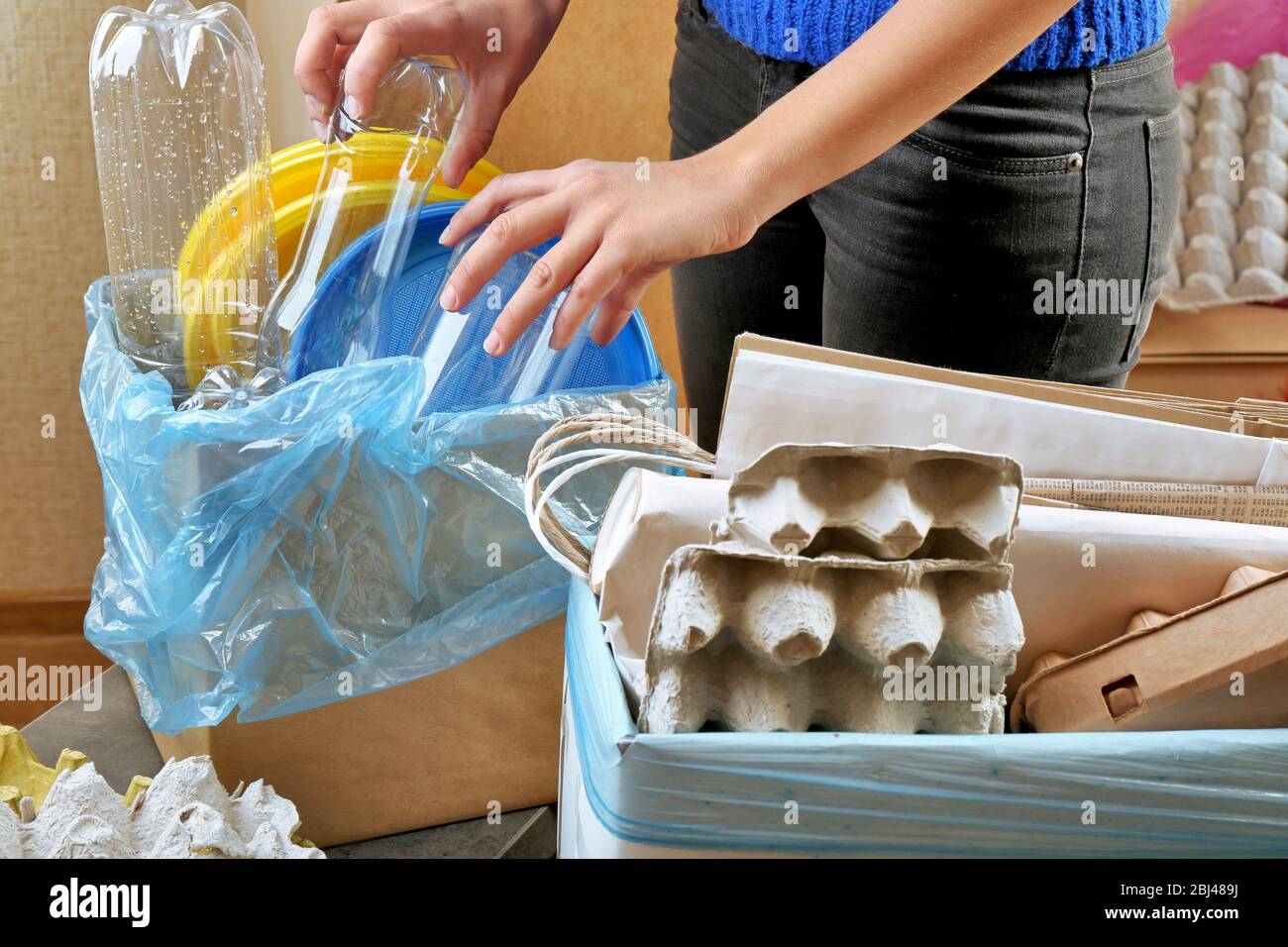 Woman sorting waste, close-up Stock Photo - Alamy
