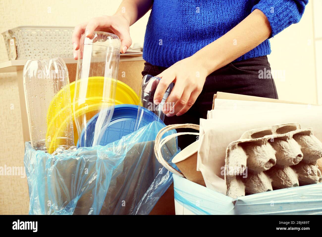 Woman sorting waste, close-up Stock Photo - Alamy
