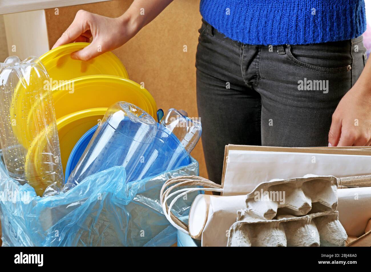 Woman sorting waste, close-up Stock Photo - Alamy