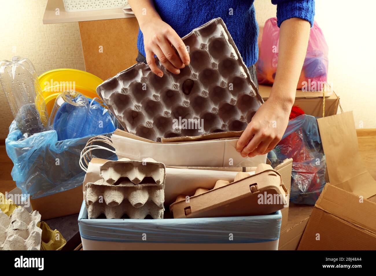 Woman sorting waste, close-up Stock Photo - Alamy