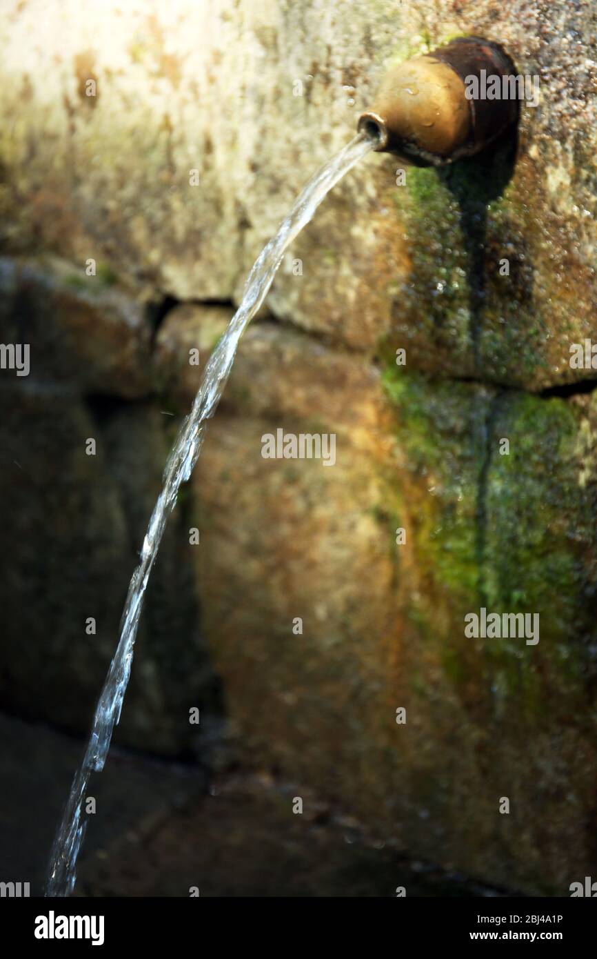 Jet of drinking spring water from the rocks Stock Photo - Alamy