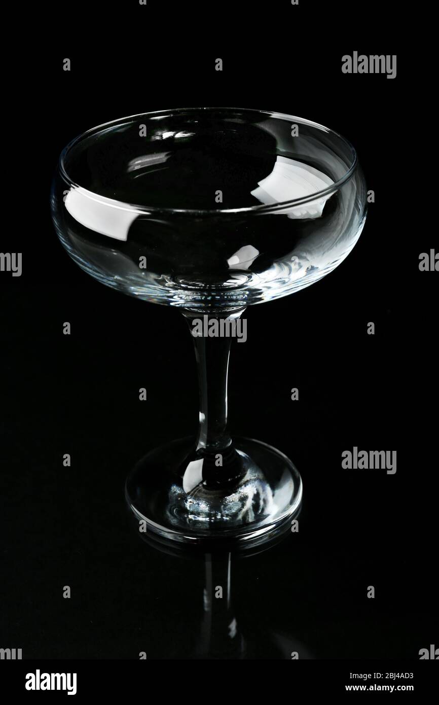 Empty cocktail glass on black background Stock Photo - Alamy