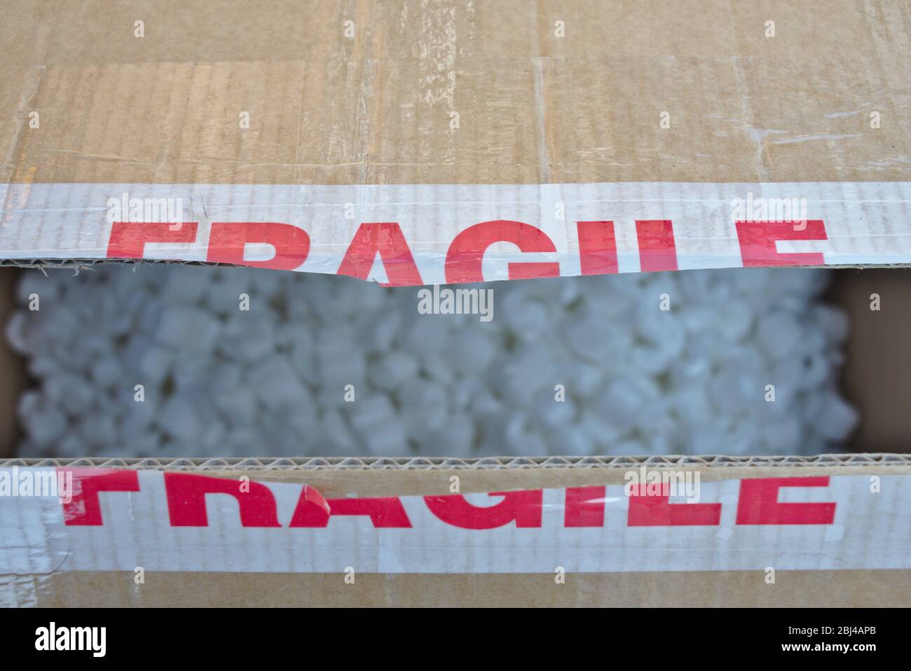 Cardboard box packaging with Fragile warning tape Stock Photo - Alamy