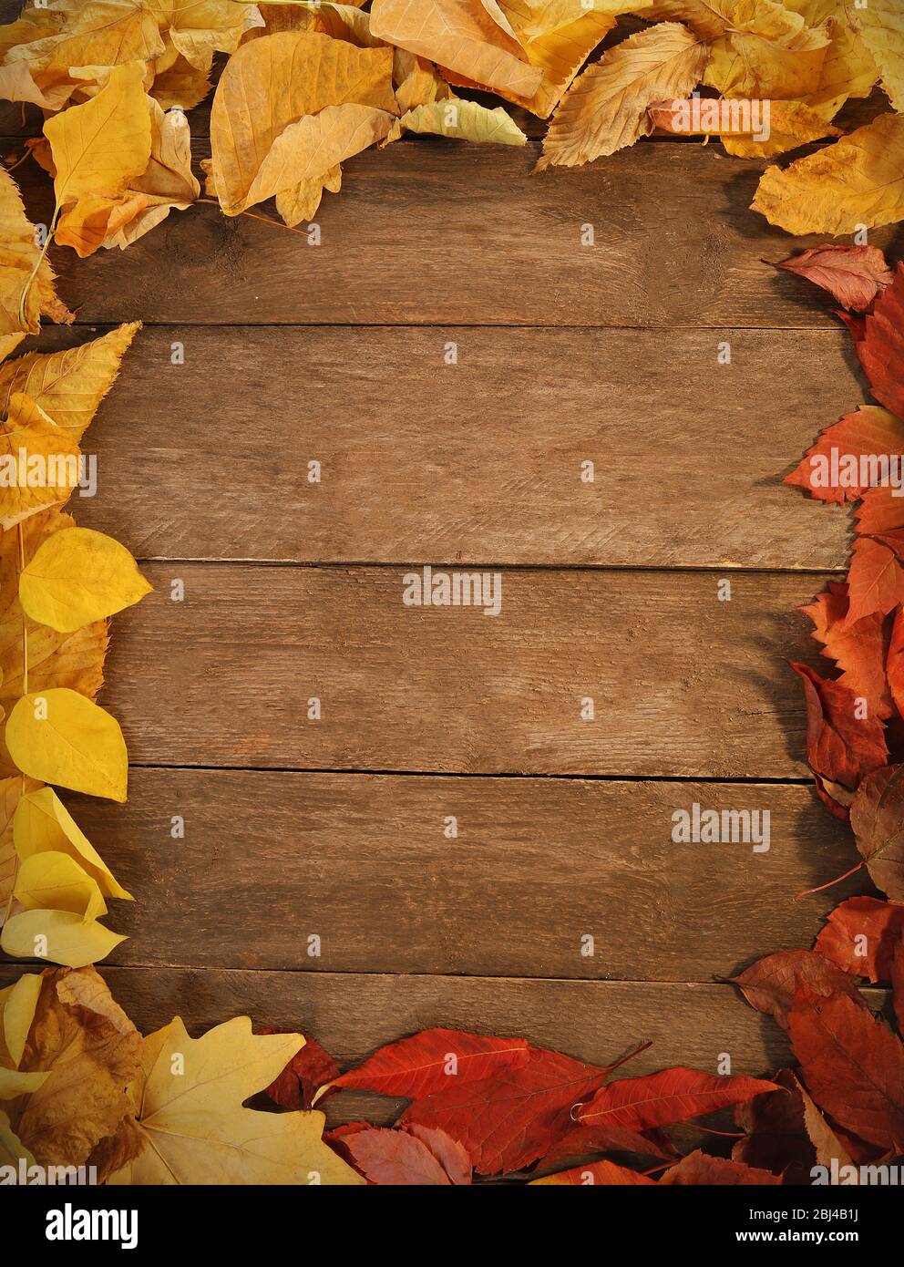 Colourful frame of autumn leaves, on wooden background Stock Photo - Alamy