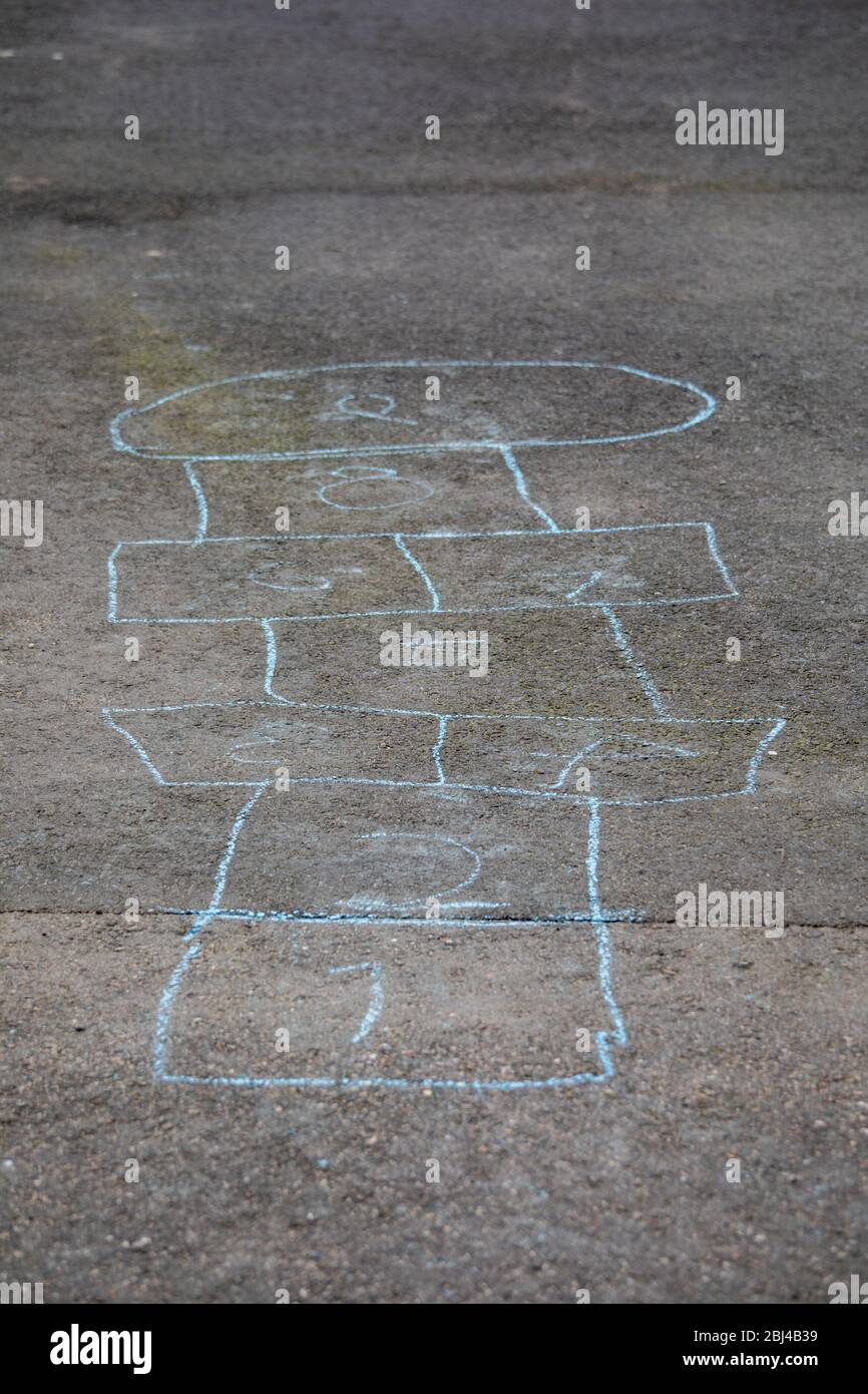 Hopscotch playground game drawn with chalk on pavement Stock Photo - Alamy