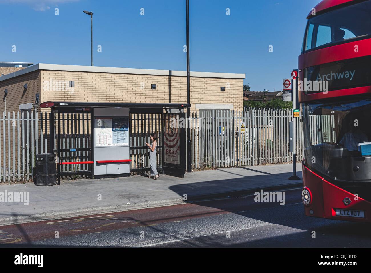 London/UK-26/07/18: a woman waiting for a bus on York Way bus stop in ...