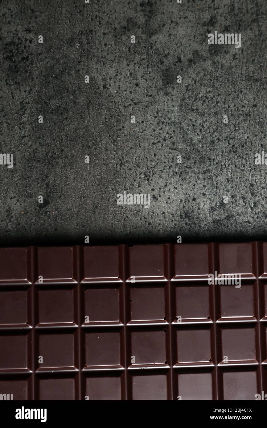 Chocolate bar on dark grey background Stock Photo - Alamy