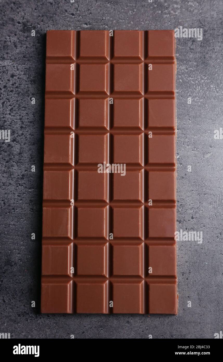 Chocolate bar on dark grey background Stock Photo - Alamy