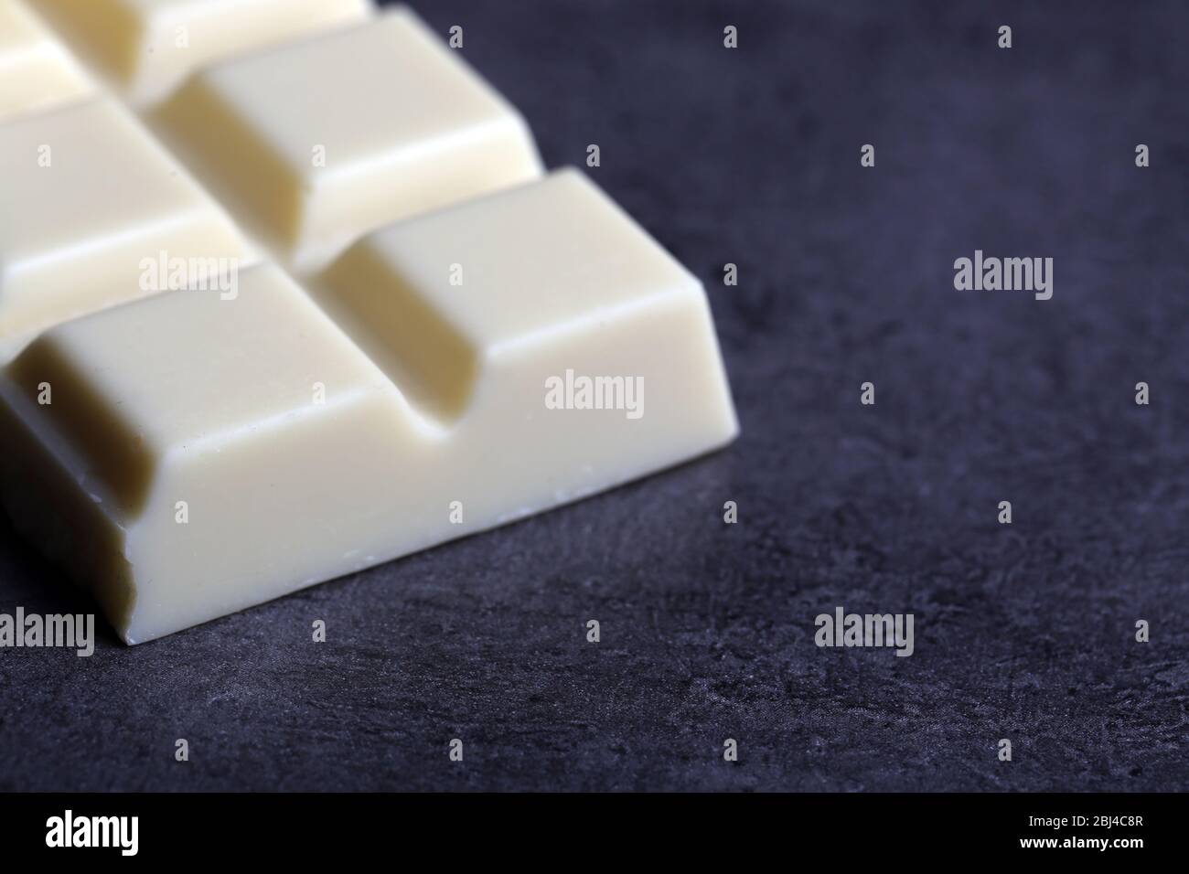White chocolate pieces on gray background Stock Photo - Alamy