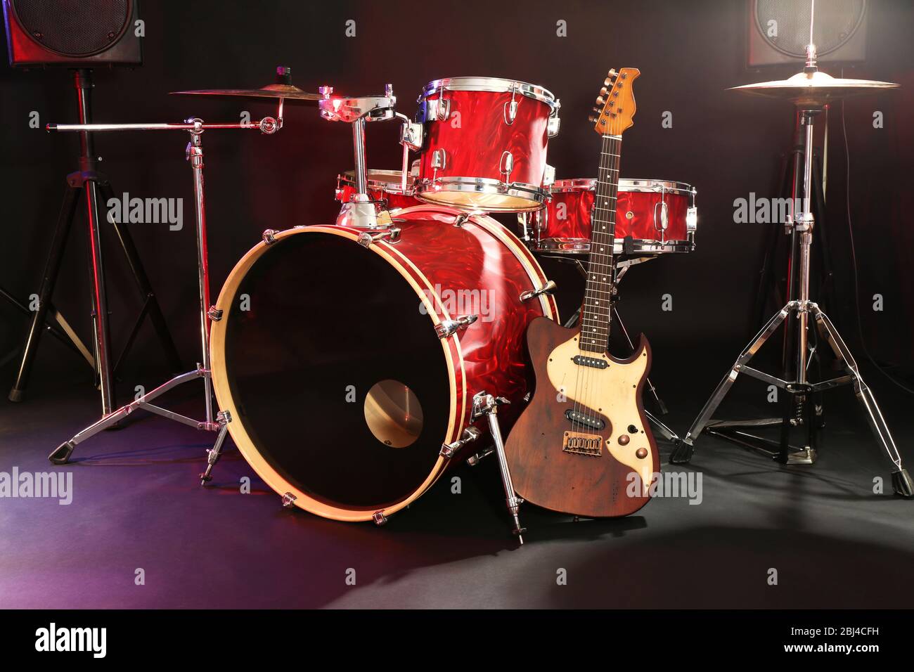 Musical instruments on a stage on dark background Stock Photo - Alamy