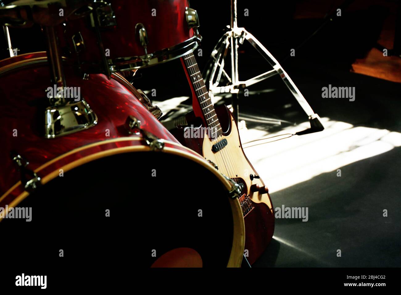 Musical instruments on a stage on dark background Stock Photo - Alamy