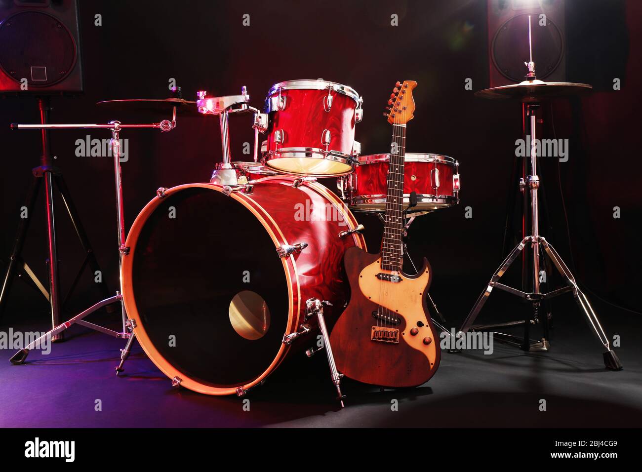 Musical instruments on a stage on dark background Stock Photo - Alamy