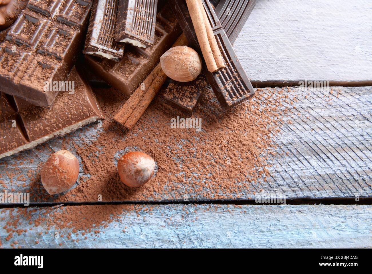 Chocolate sweets with powder on wooden background Stock Photo - Alamy