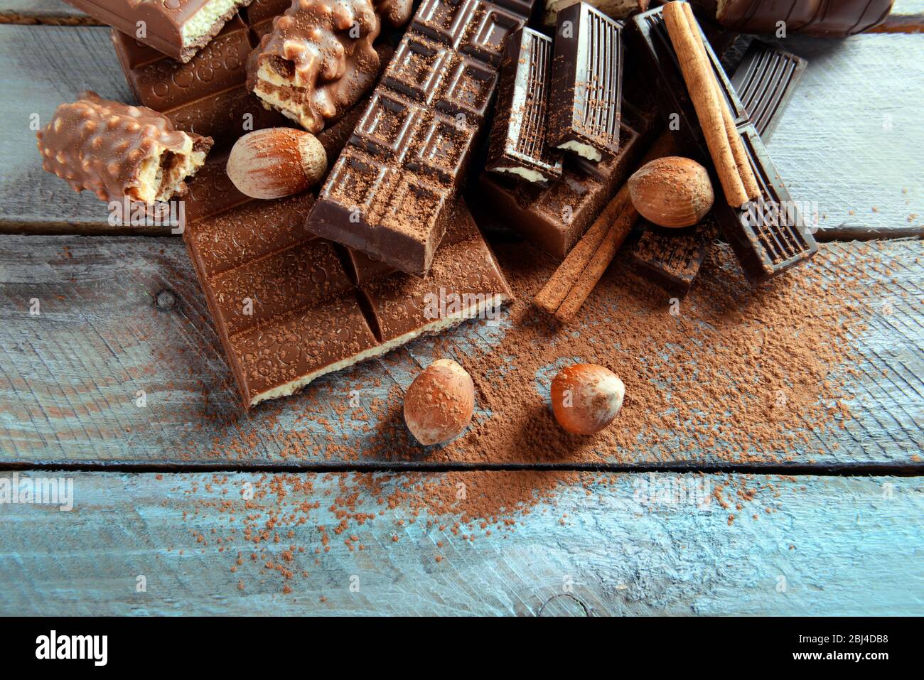 Chocolate sweets with powder on wooden background Stock Photo - Alamy