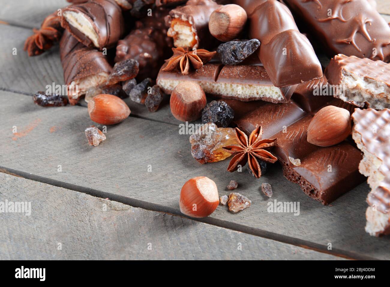 Chocolate sweets with powder on wooden background Stock Photo - Alamy