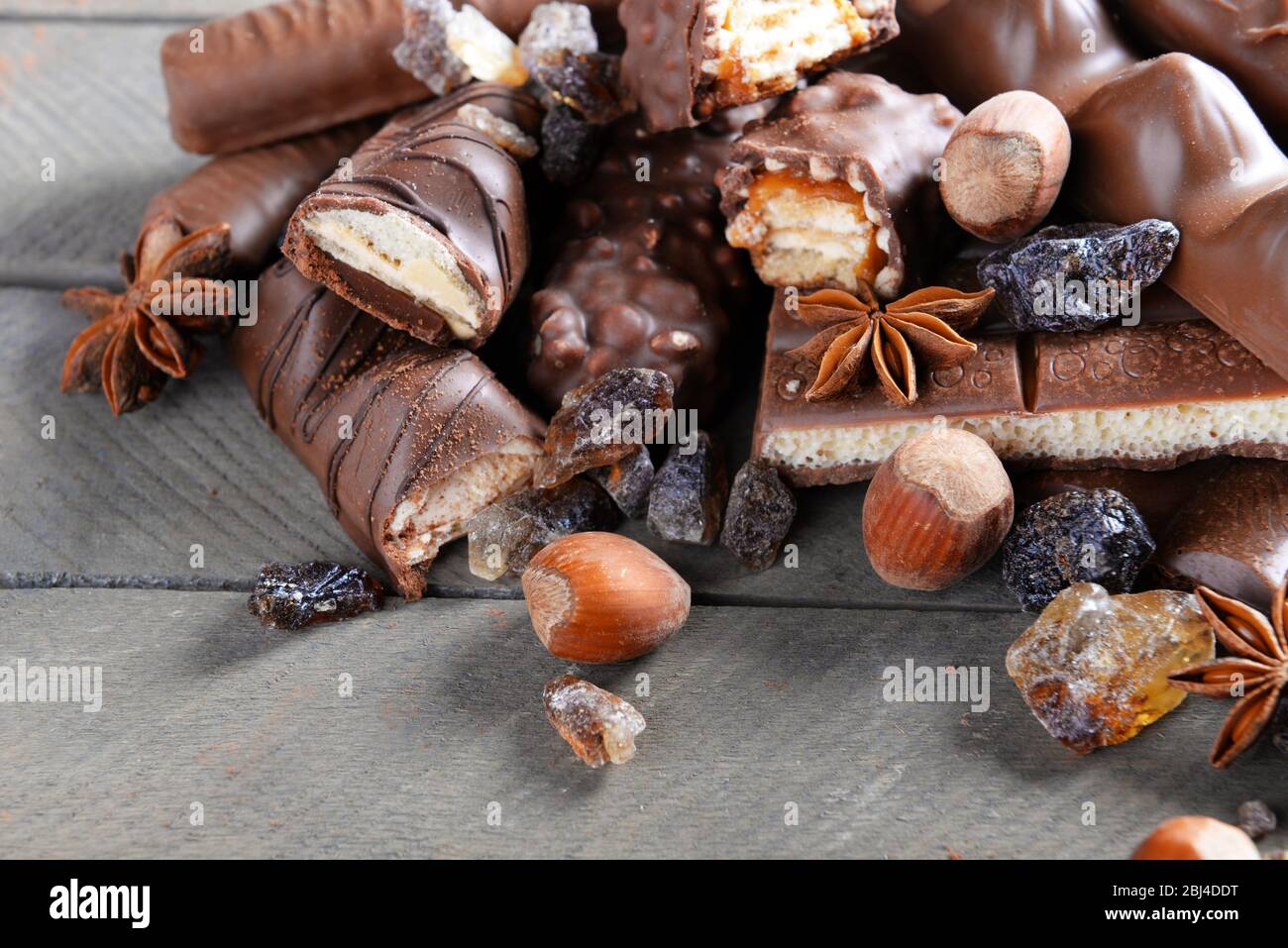 Chocolate sweets with powder on wooden background Stock Photo - Alamy