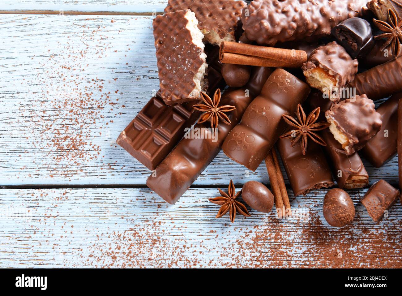 Chocolate sweets with powder on wooden background Stock Photo - Alamy