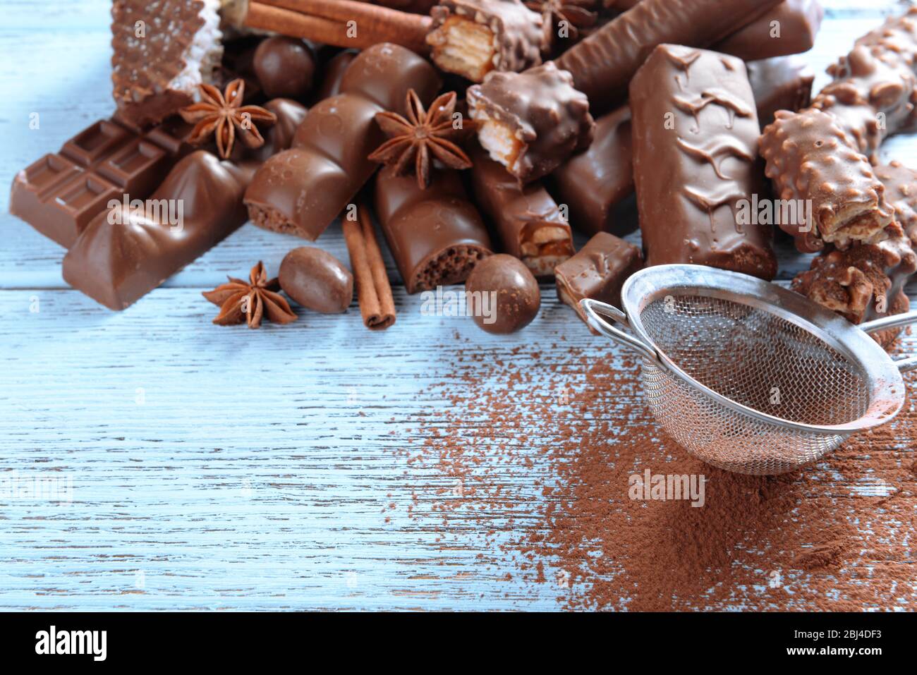 Chocolate sweets with powder on wooden background Stock Photo - Alamy