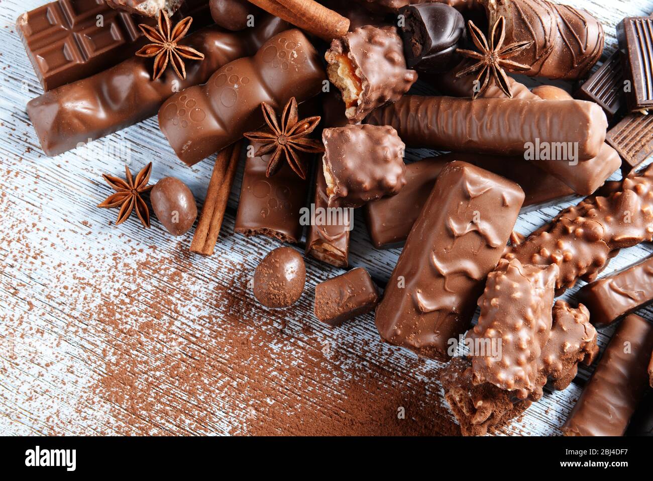 Chocolate sweets with powder on wooden background Stock Photo - Alamy