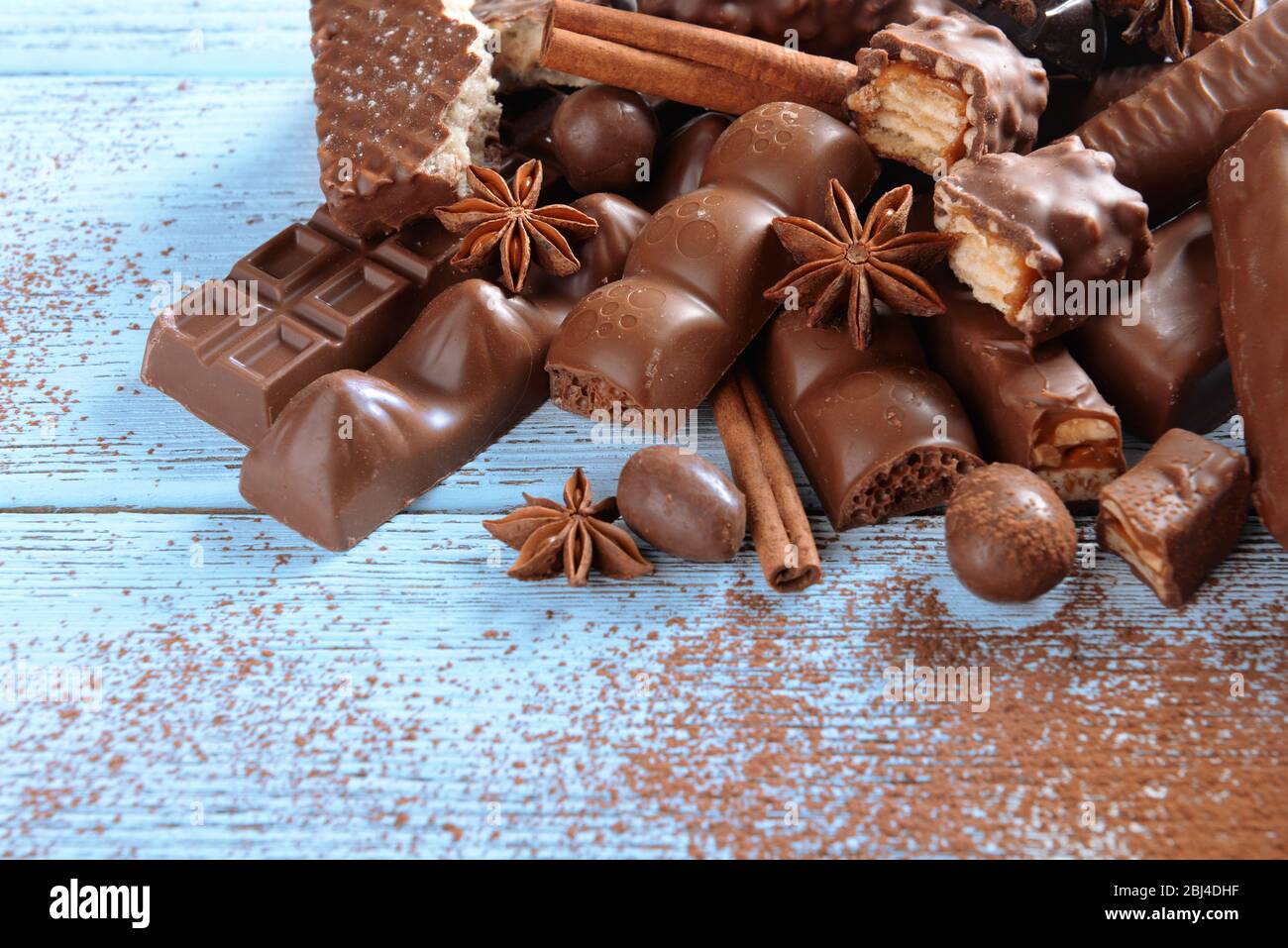 Chocolate sweets with powder on wooden background Stock Photo - Alamy