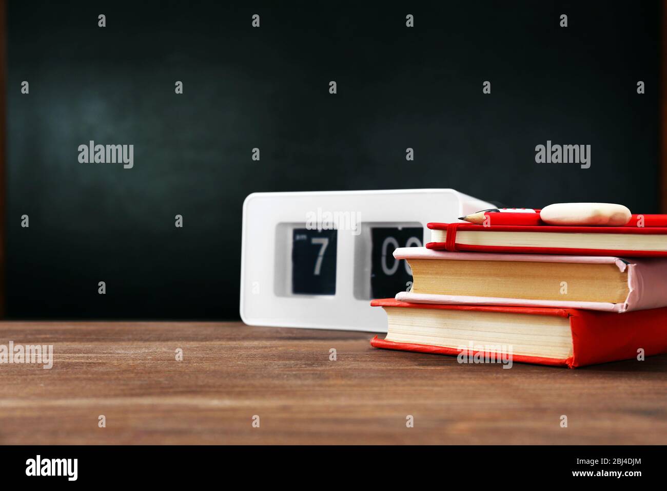 Books and clock on desk background Stock Photo - Alamy