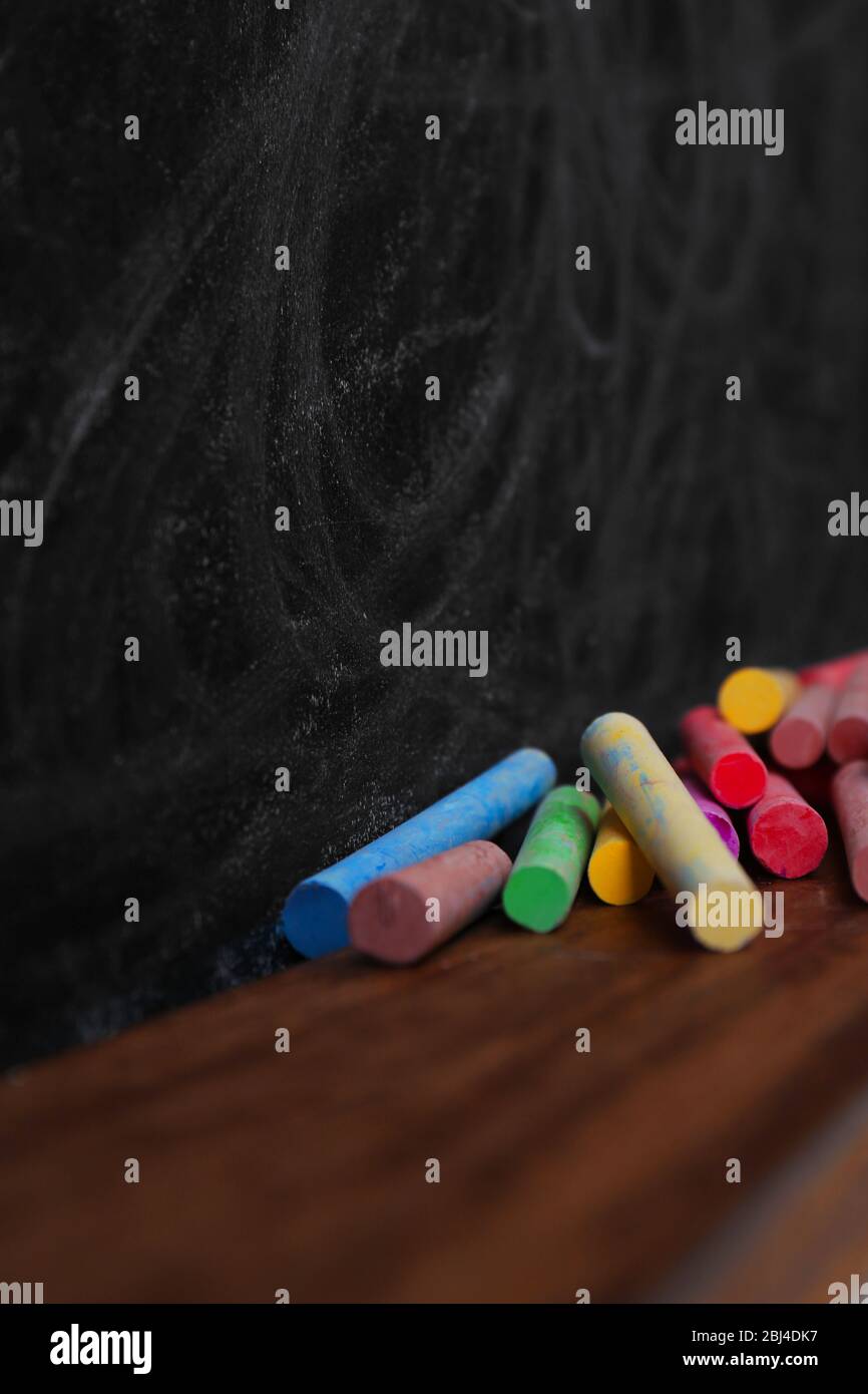 Many chalks on desk background Stock Photo - Alamy