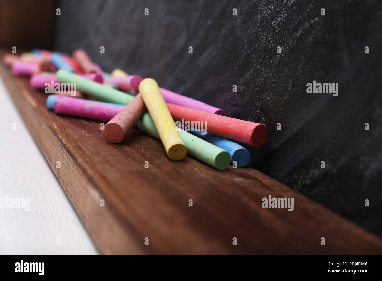 Many chalks on desk background Stock Photo - Alamy