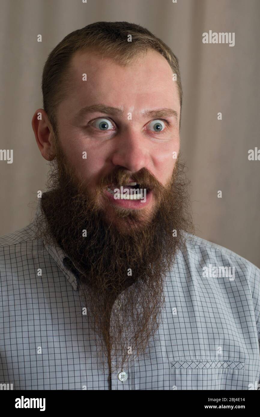 Portrait of a white serious angry man with a long beard Stock Photo - Alamy