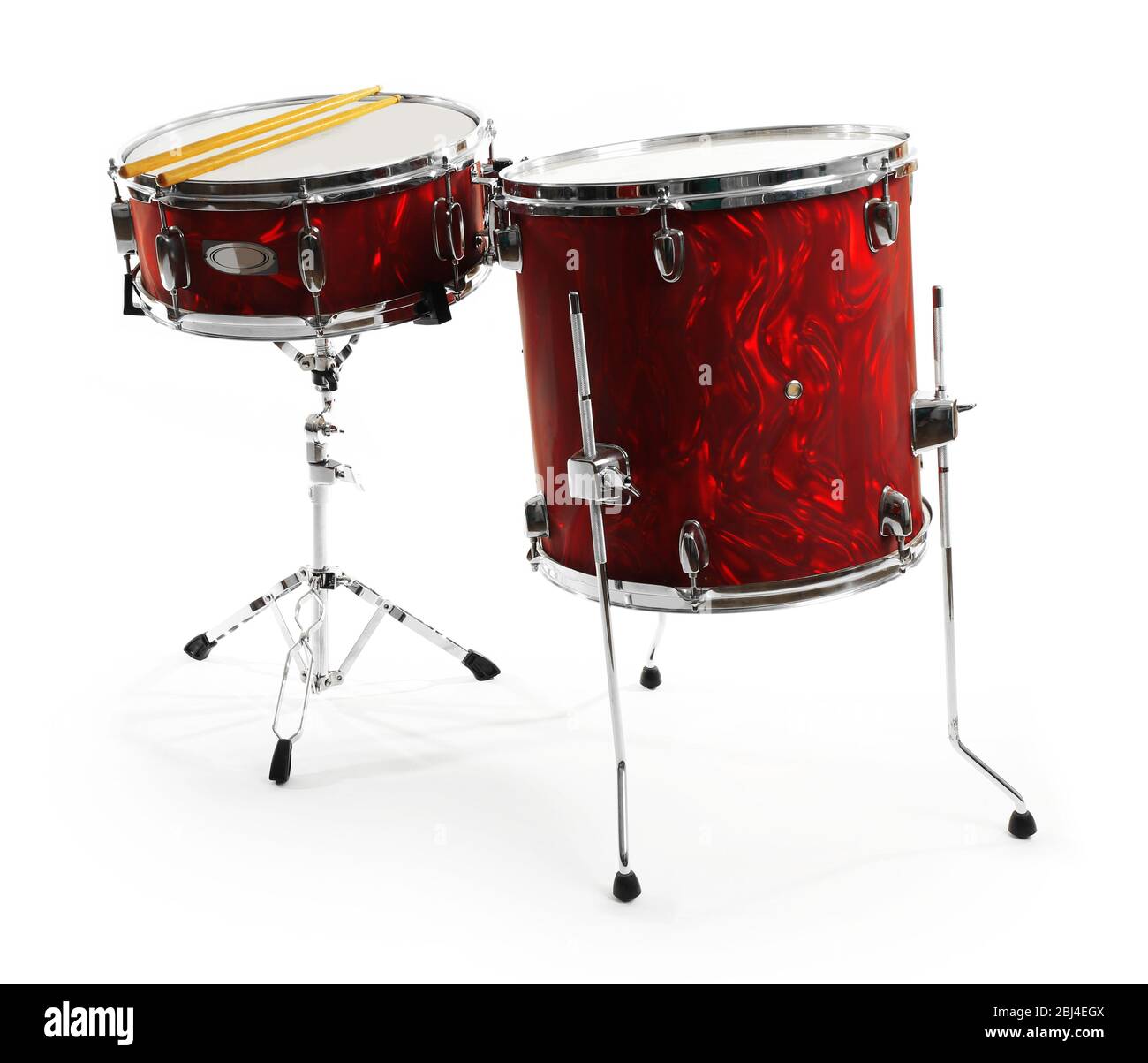 Red drums with drum sticks isolated on white background Stock Photo - Alamy